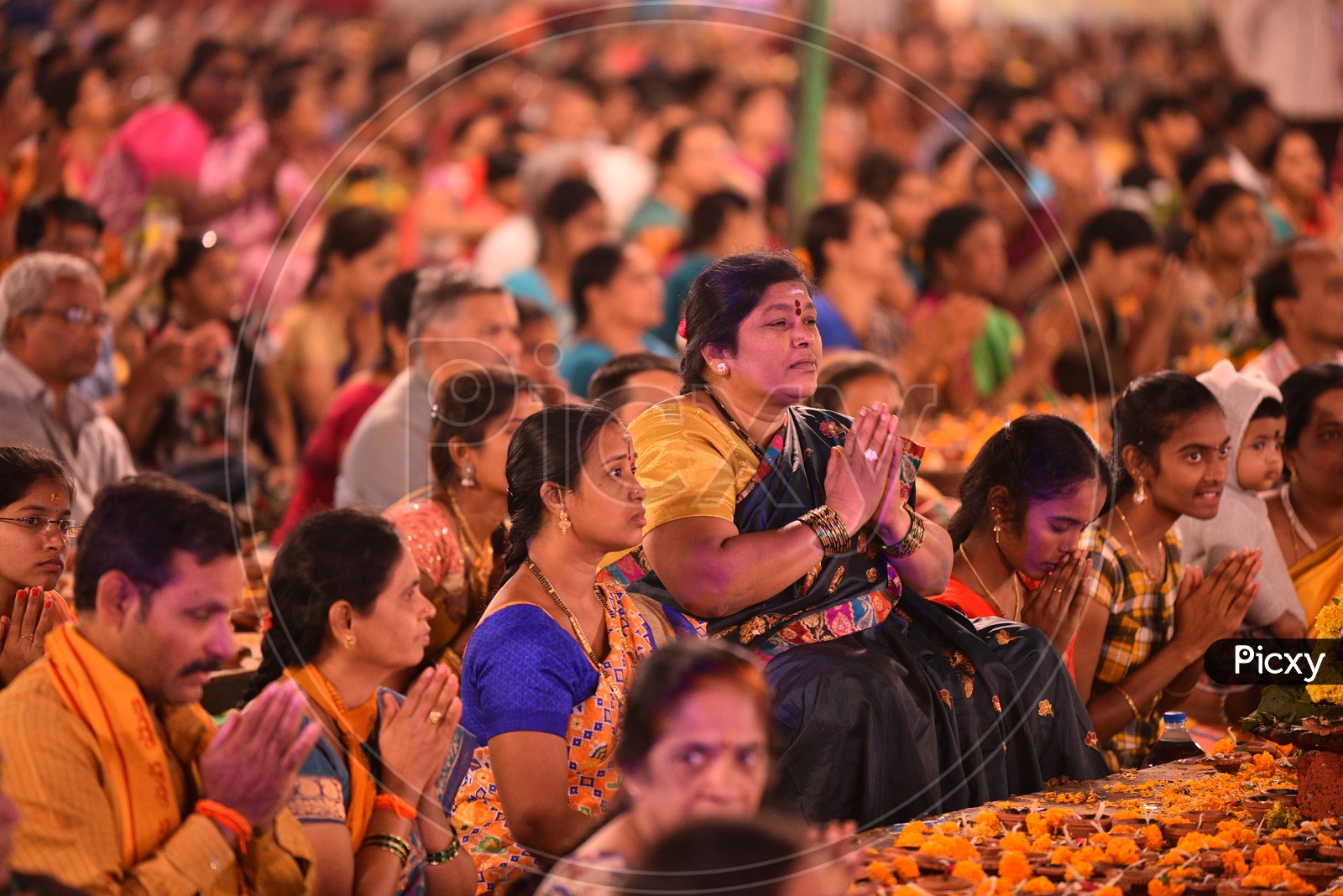 Image of A woman prays at a gathering by Hindu Devotees, Koti ...