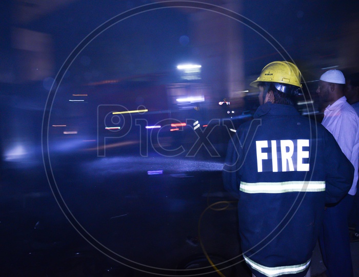 Image of Fireman Fighting to take control over a Fire Mishap ...