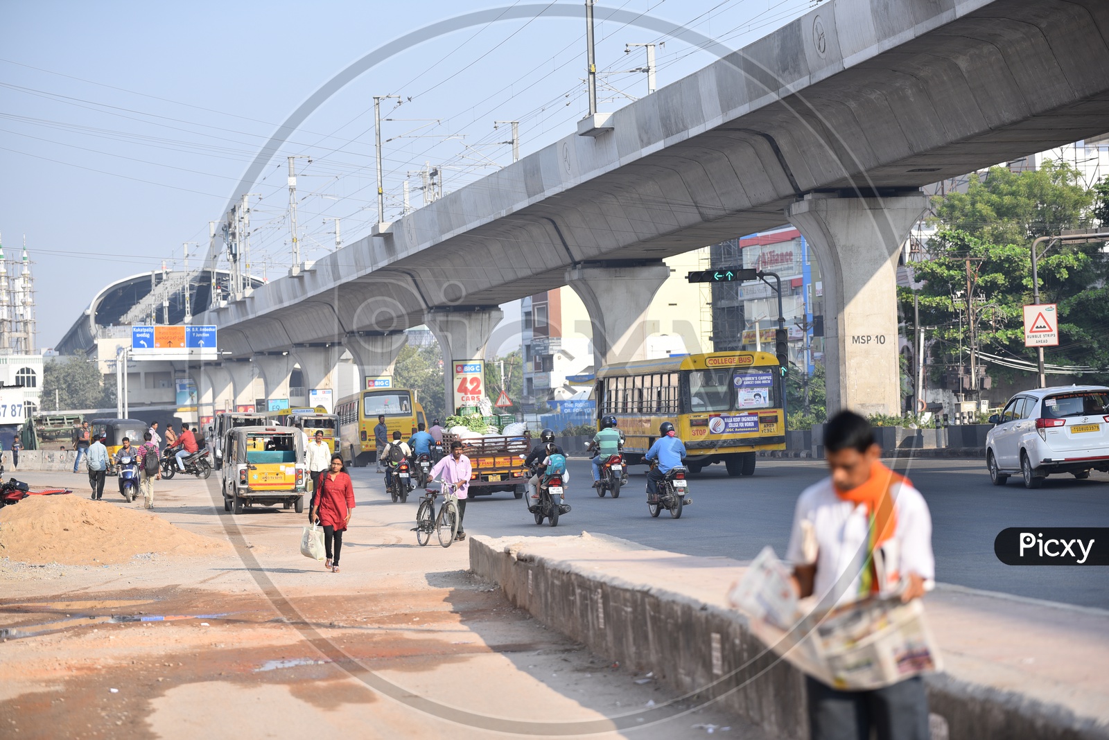 Image of Man reading newspaper by the road-UF016022-Picxy