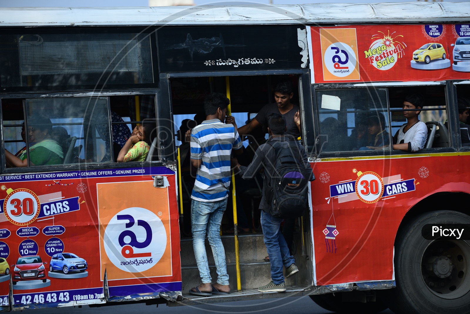 Image of People on the Steps of a Public Bus-JQ410615-Picxy