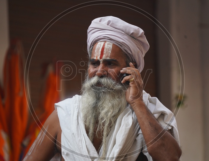 Image of Indian Hindu sadhu / Baba Talking in Phone in Pushkar Camel ...