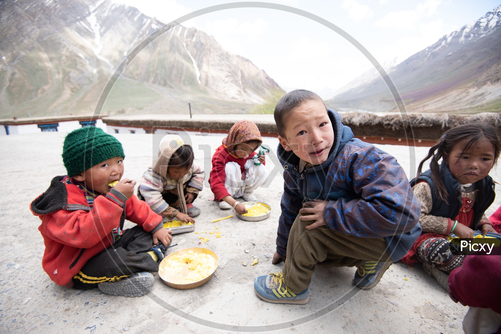 Image of Kids having their food in Spiti Valley with Mountains in ...