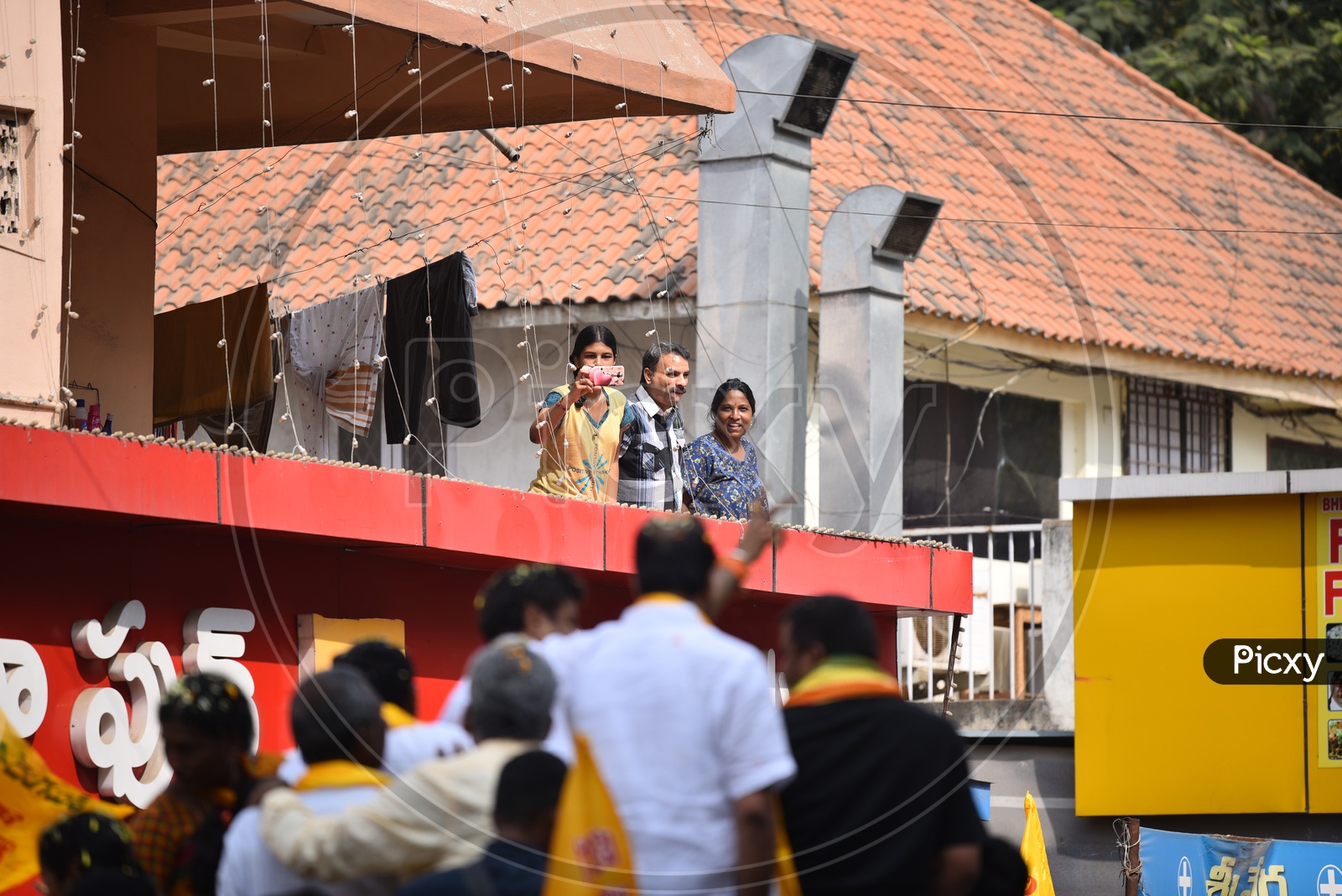 Image of Residents Capturing TDP Road Show in Their Mobiles-WI325753-Picxy
