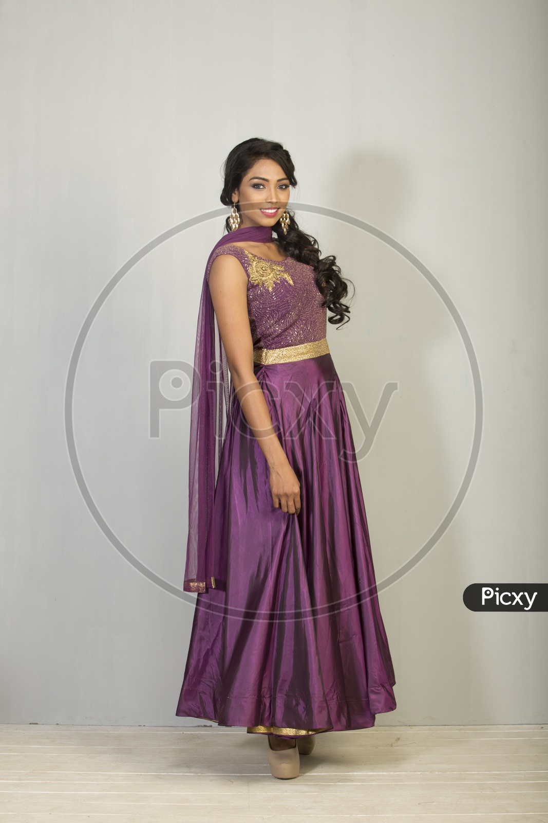 Image of Indian girl dressed up in purple dress portrait in Studio ...