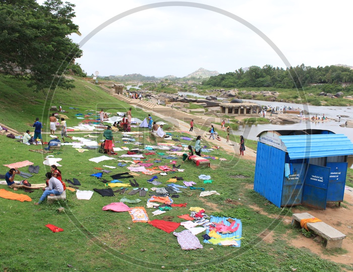 Image of People drying clothes on the banks of the river-ES378740-Picxy