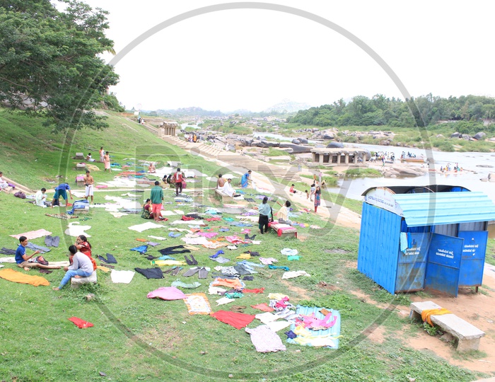 Image of People drying clothes on the banks of the river-HH140039-Picxy