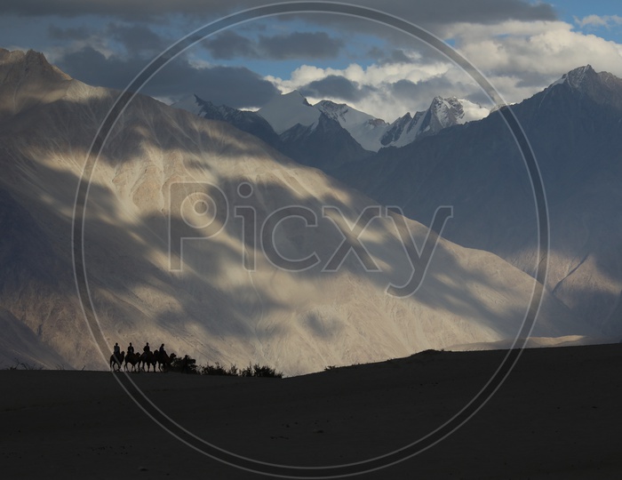 Image of Beautiful Landscape of Snow Capped Mountains with huge clouds ...