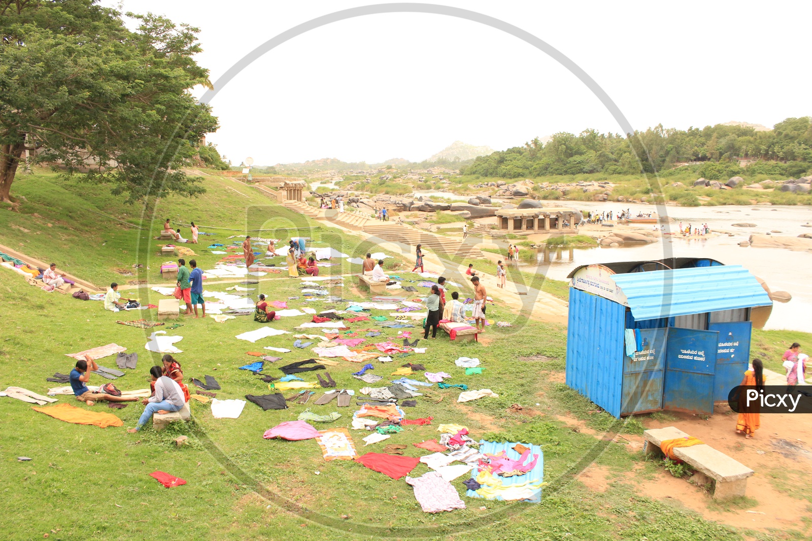 Image of People drying clothes on the banks of the river-ES378740-Picxy