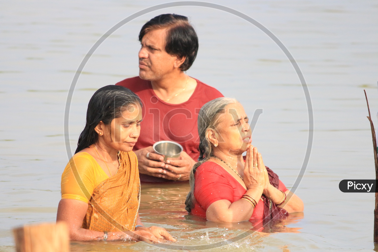 Image of An Indian Hindu Family Taking A Holy Bath In River Godavari ...