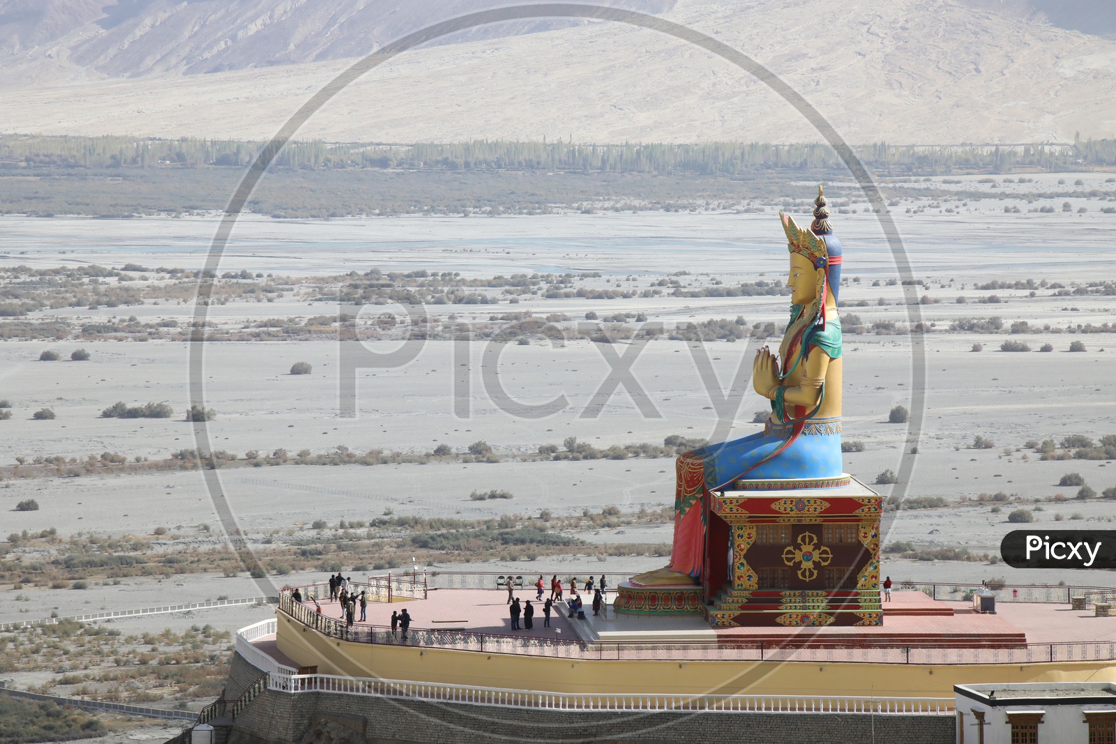 Image of Statue of Buddha in leh with snow capped mountains in the ...