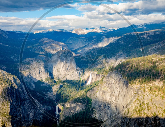 Image of A Beautiful Valley with a Water Falls and Mountains-DM781759-Picxy