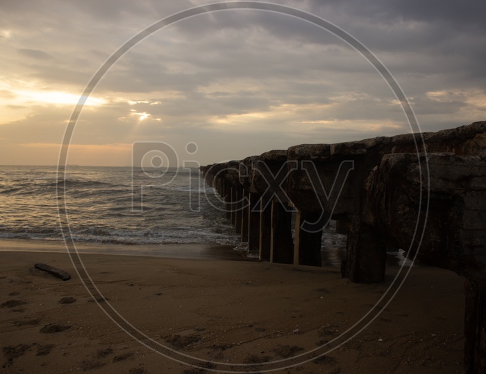 Image of A Pier Into The Sea Long View Shot with Waves in Fore Ground ...