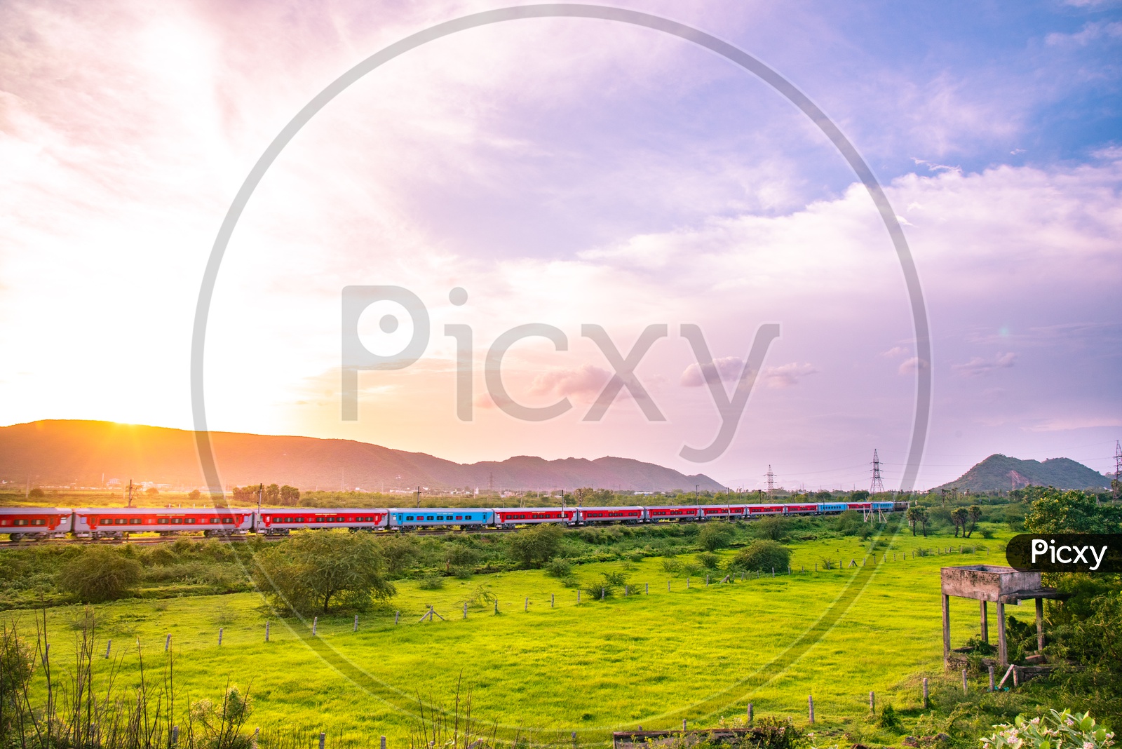 Image Of A Train Running During Sunset At Krishna Junction