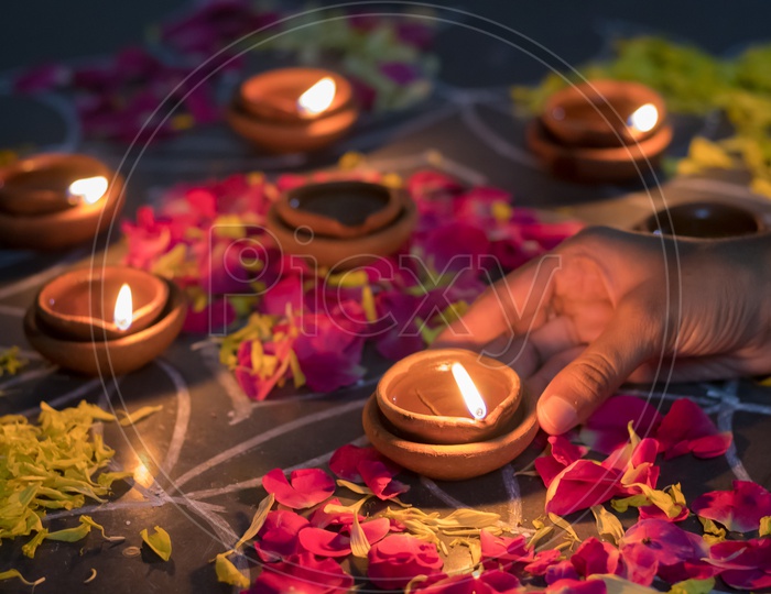 Image of Indian Hindu Festival Diwali Dias Lighting Up by women Closeup ...