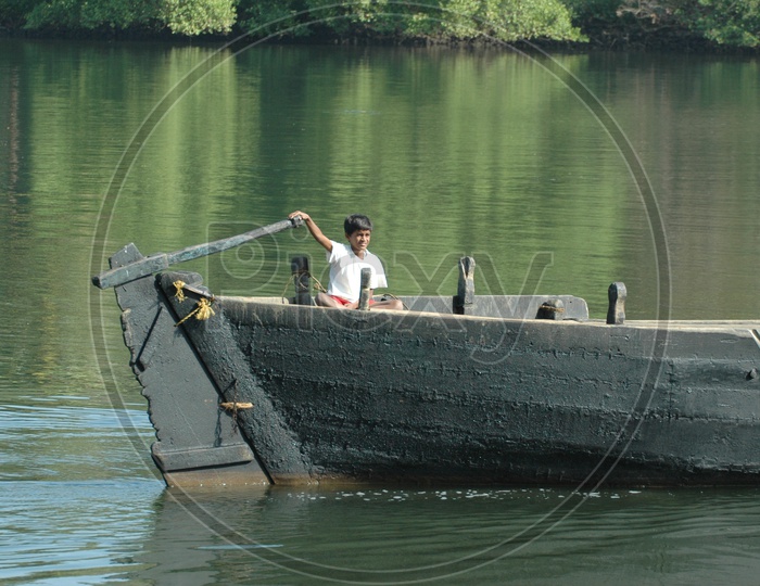 Image of Indian Boy in a Boat-ME986765-Picxy