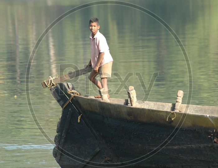 Image of Indian Boy in a Boat-AB392864-Picxy