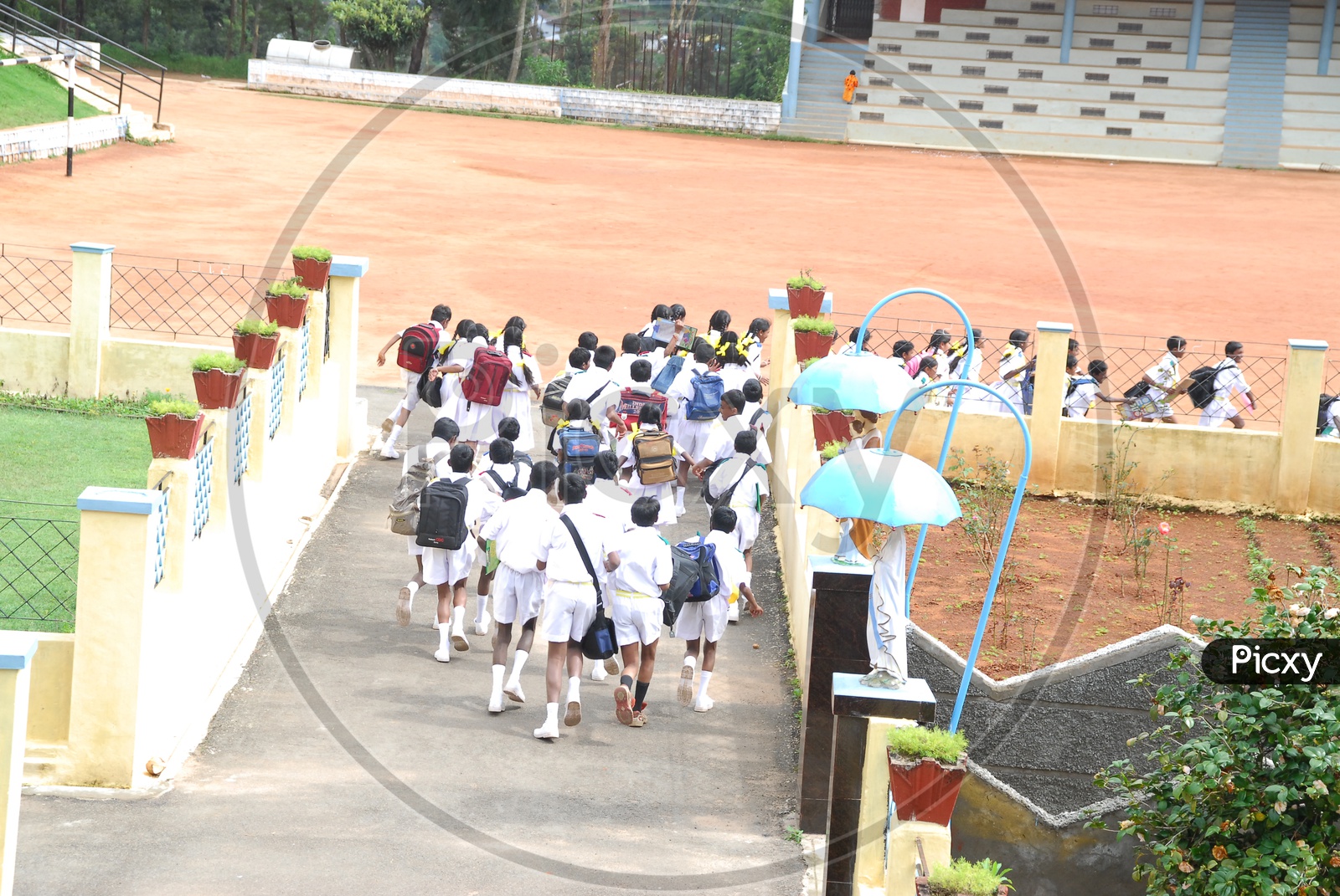 Image of Aerial View of School Children Running From Classes After ...