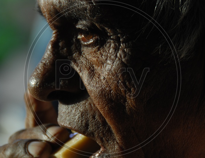 Image of Photograph of a old man eating sweet / People Face-FK604366-Picxy