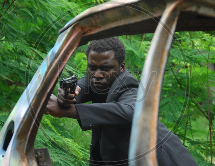 Image of African American holding a gun. Behind the scenes or the ...