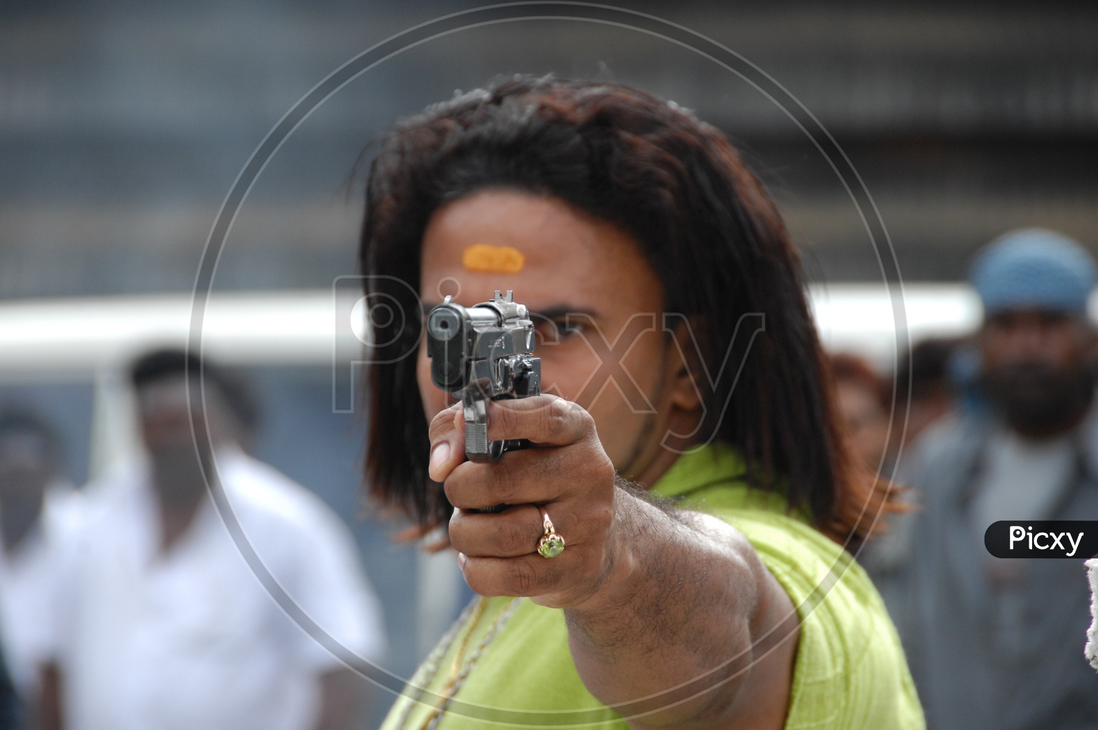 Image of Telugu/Tamil/South Indian actor holding a gun. Behind the ...