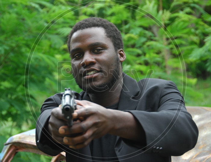 Image of African American holding a gun. Behind the scenes or the ...