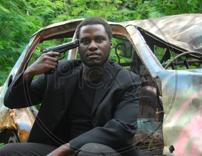 Image of African American holding a gun. Behind the scenes or the ...