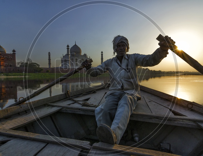 Image of Man sailing boat with Taj Mahal in the background and ...