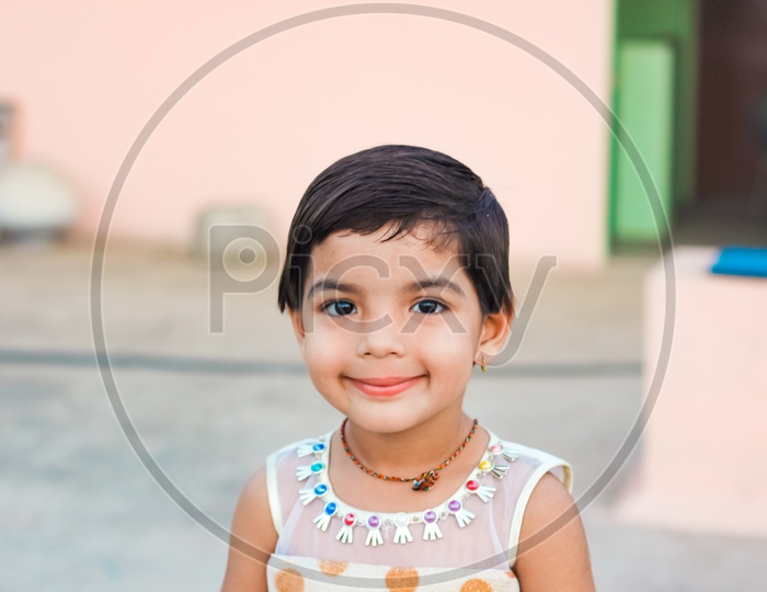 Image of Indian Girl Child With Smiling Face Closeup Shot-QR838495-Picxy