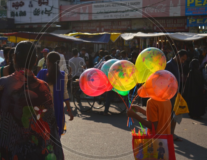 Image of A Small Boy Vendor Selling Balloons-XS989827-Picxy