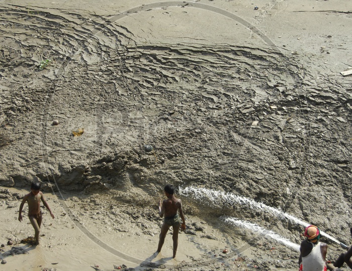 Image of Indian Boys playing in Wet Mud-ID928021-Picxy