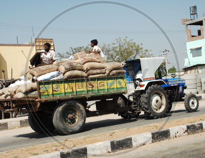 Image of Rice Bags Carrying On a Tractor-AG510433-Picxy