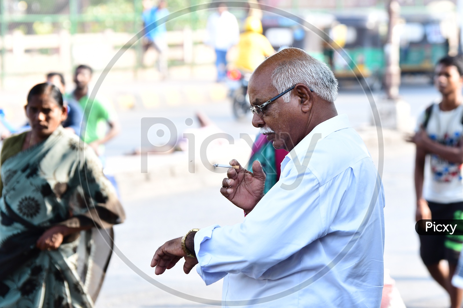 Image of Indian Bald Man smoking a cigarette-ZT224577-Picxy