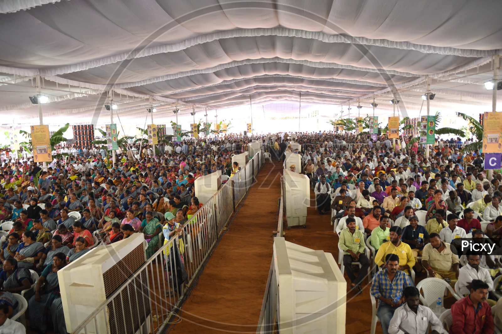 Image of Crowd Of People Sitting on Chairs During A Political Party ...