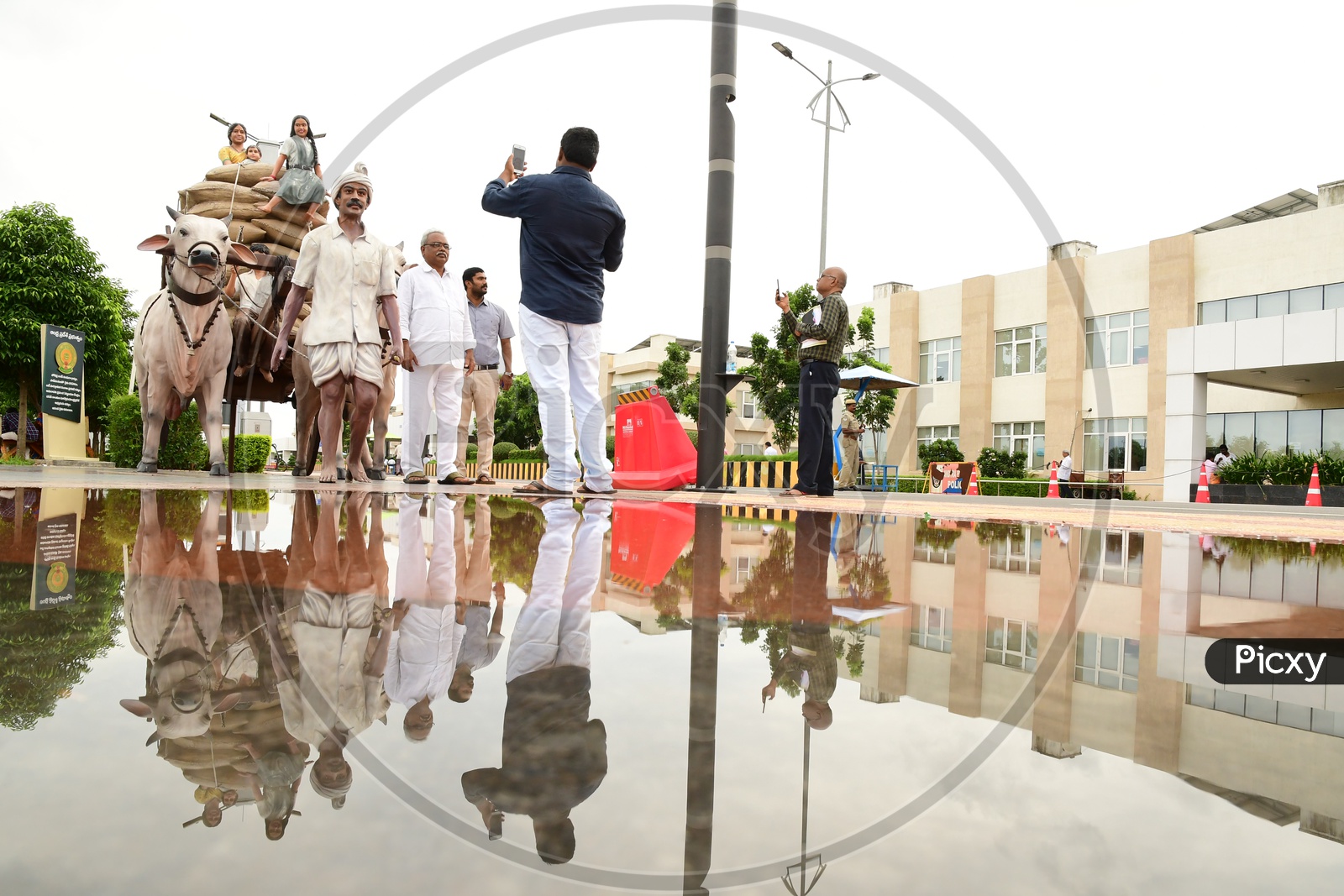 Image of Reflection of Indian Men taking pictures of Statues-BA868380-Picxy