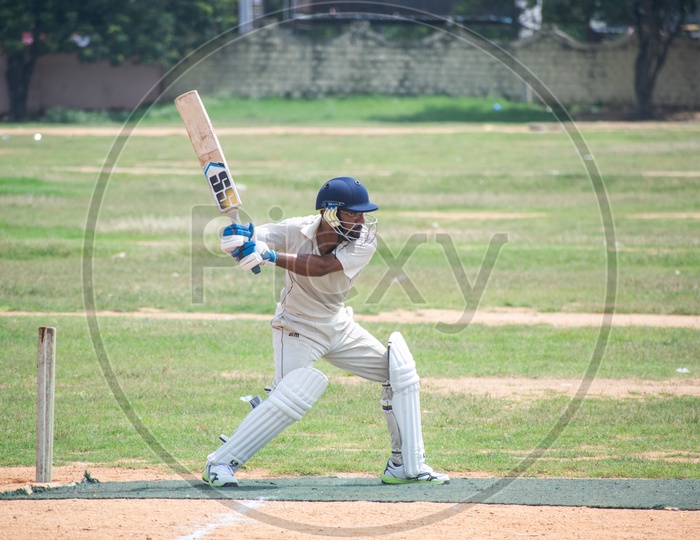 Image of Cricket batsman in an action to hit the ball-ZG299833-Picxy