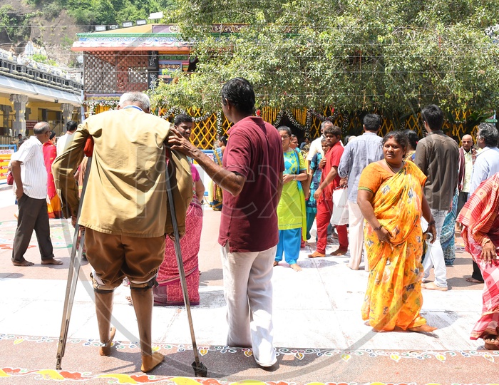 Image of An Indian Man helping Physically handicapped elderly man ...