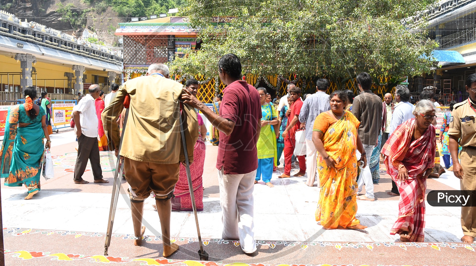 Image of An Indian Man helping Physically handicapped elderly man ...