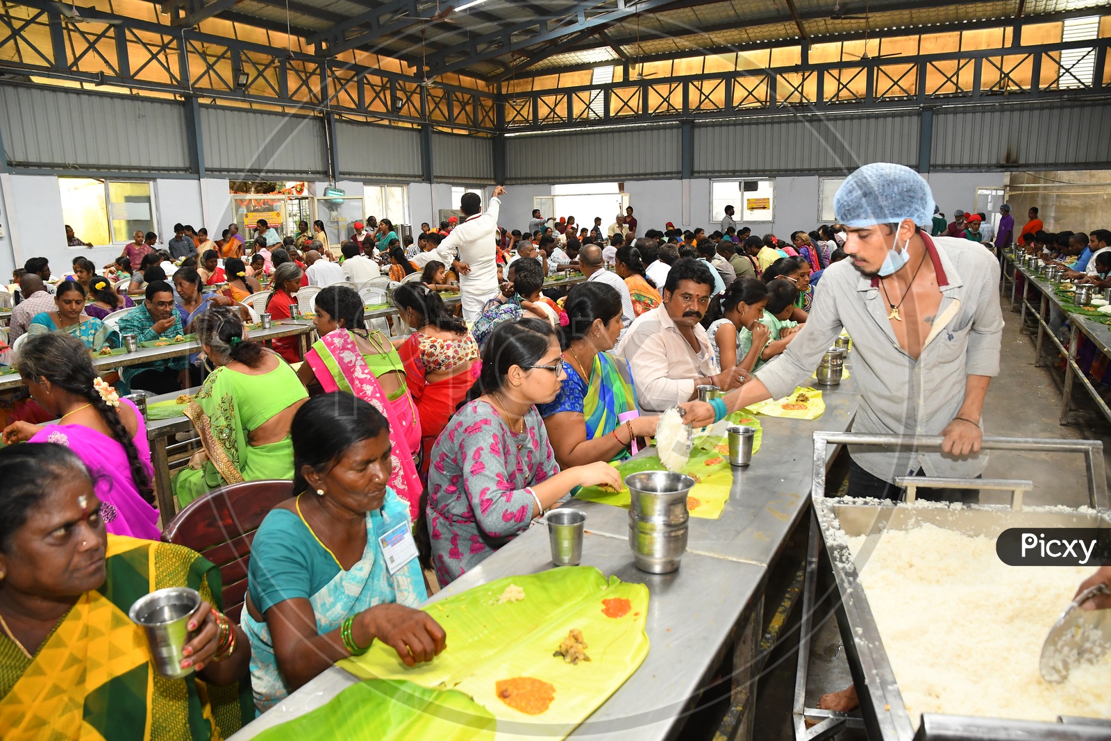 Image of Volunteers Serving Food For Devotees Called As Annadanam Or ...