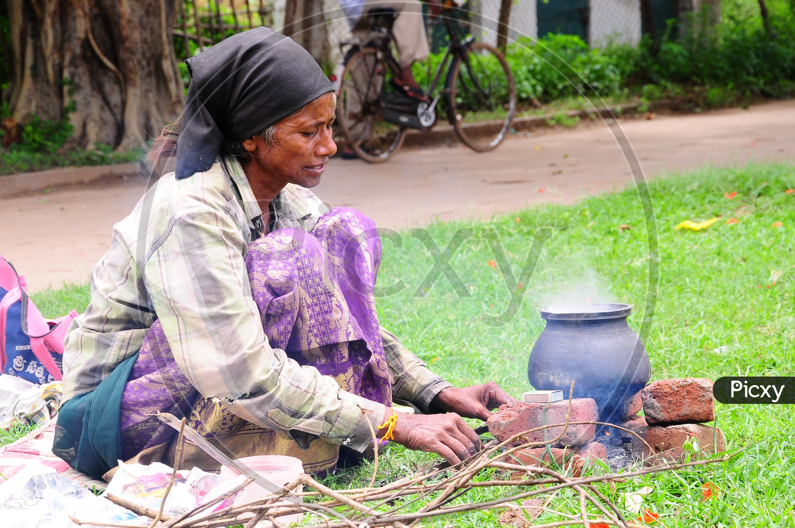 Image of Indian Old Woman cooking in a traditional way-RE646329-Picxy