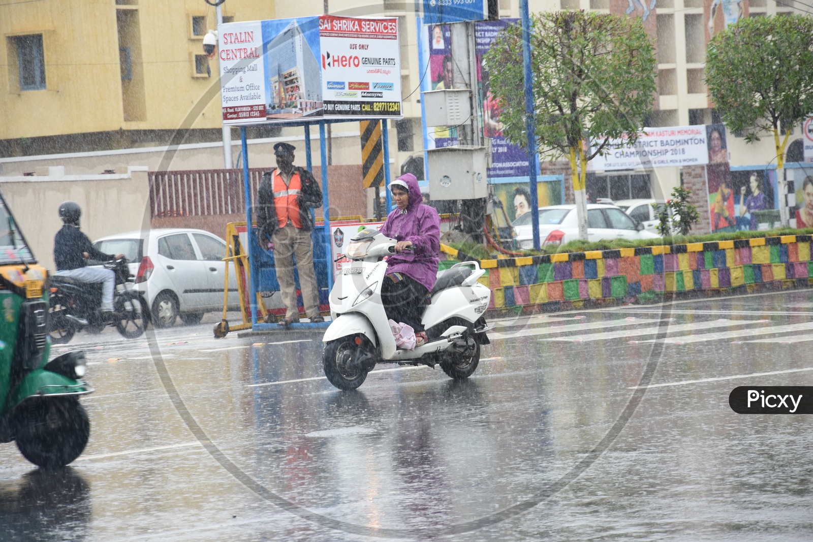 Image of Two Wheeler Commuters Commuting in Rain-NM609440-Picxy