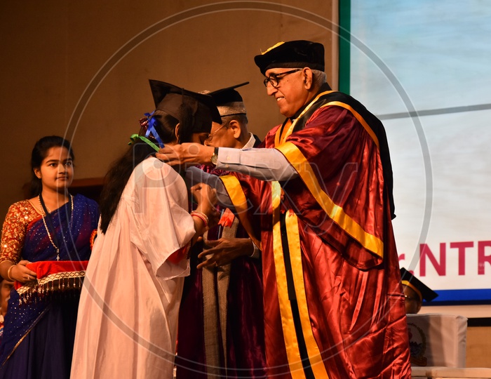 Image of Scholars Receiving Graduation Medals From a Collage Dean ...