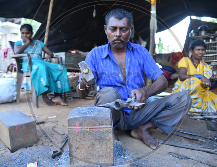 Image of Indian Blacksmith Shaping the Hot Metal using Hammer-QK534291 ...
