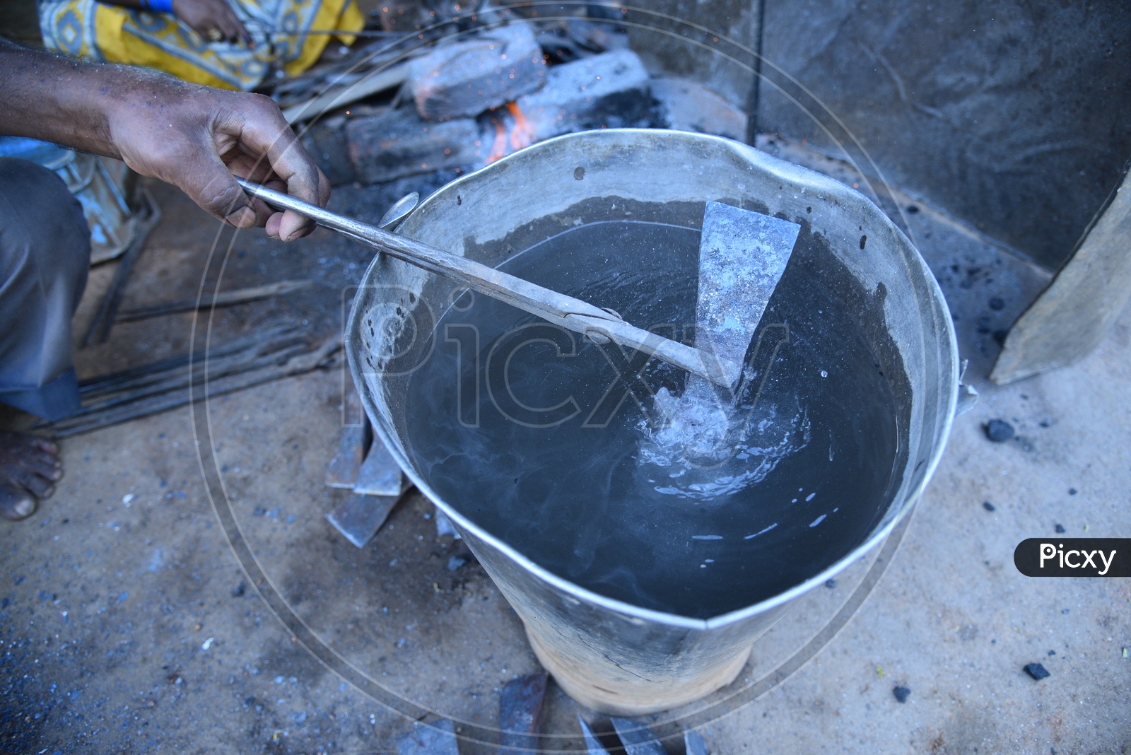 Image of Indian Blacksmith Cooling the Hot Metal in Water-TS205439-Picxy