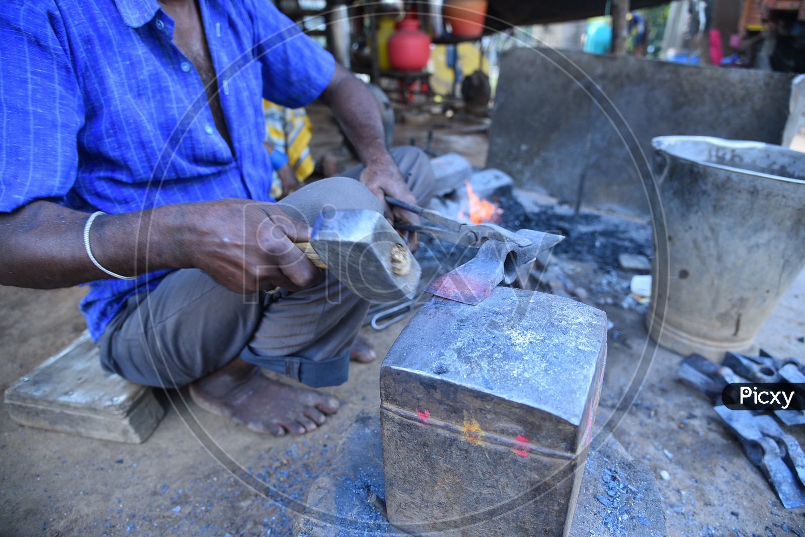 Image of Indian Blacksmith Shaping the Hot Metal using Hammer-CH046284 ...