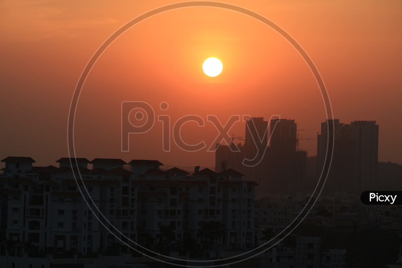 Image of Sunset Over High Rise Buildings Scape With Bright Sun As ...