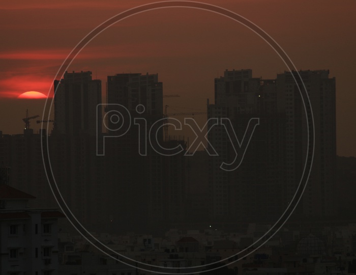 Image of Sunset Over High Rise Buildings Scape With Bright Sun As ...