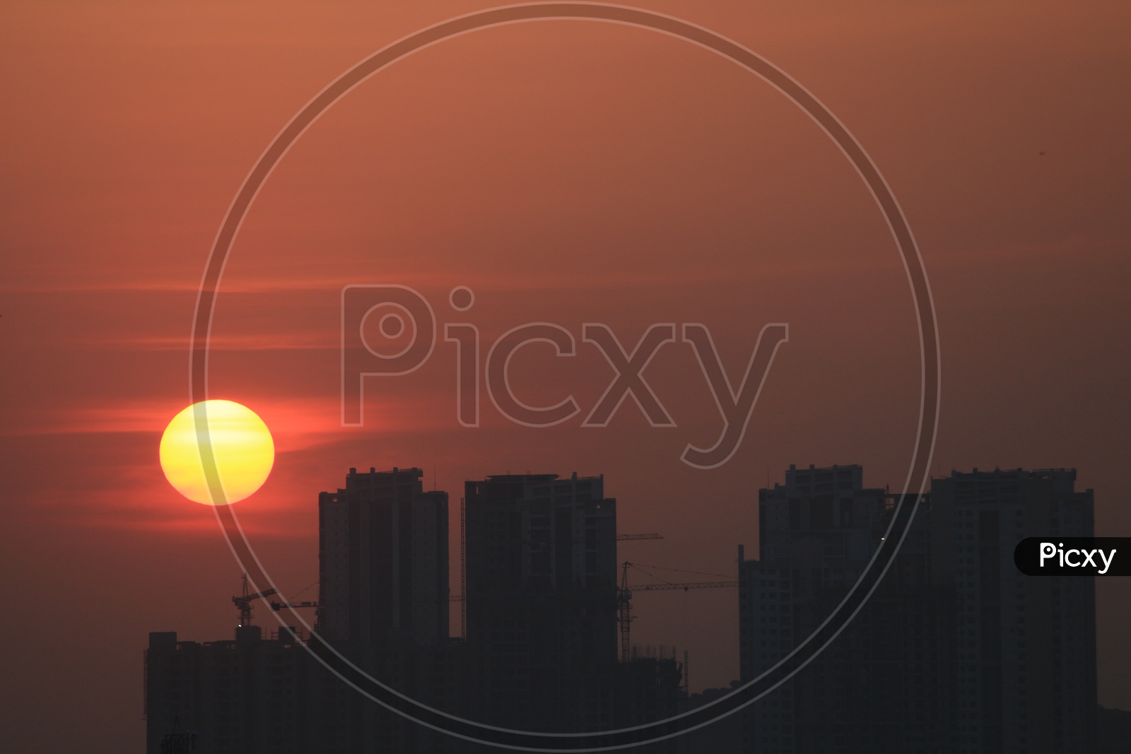 Image of Sunset Over High Rise Buildings Scape With Bright Sun As ...