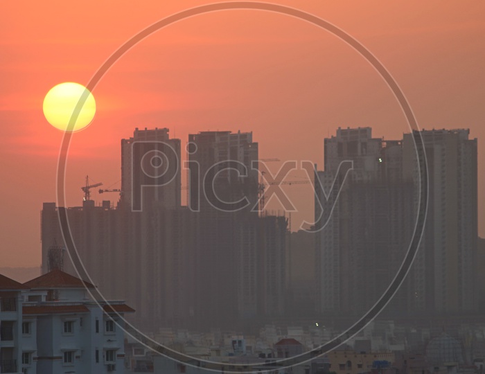 Image of Sunset Over High Rise Buildings Scape With Bright Sun As ...