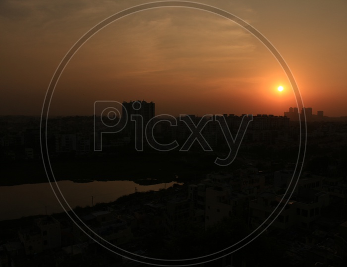 Image of Sunset Over High Rise Buildings Scape With Bright Sun As ...