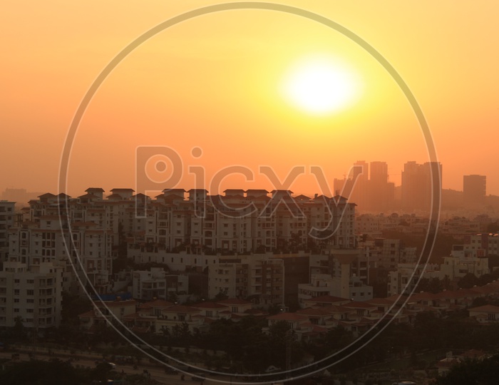 Image of Sunset Over High Rise Buildings Scape With Bright Sun As ...